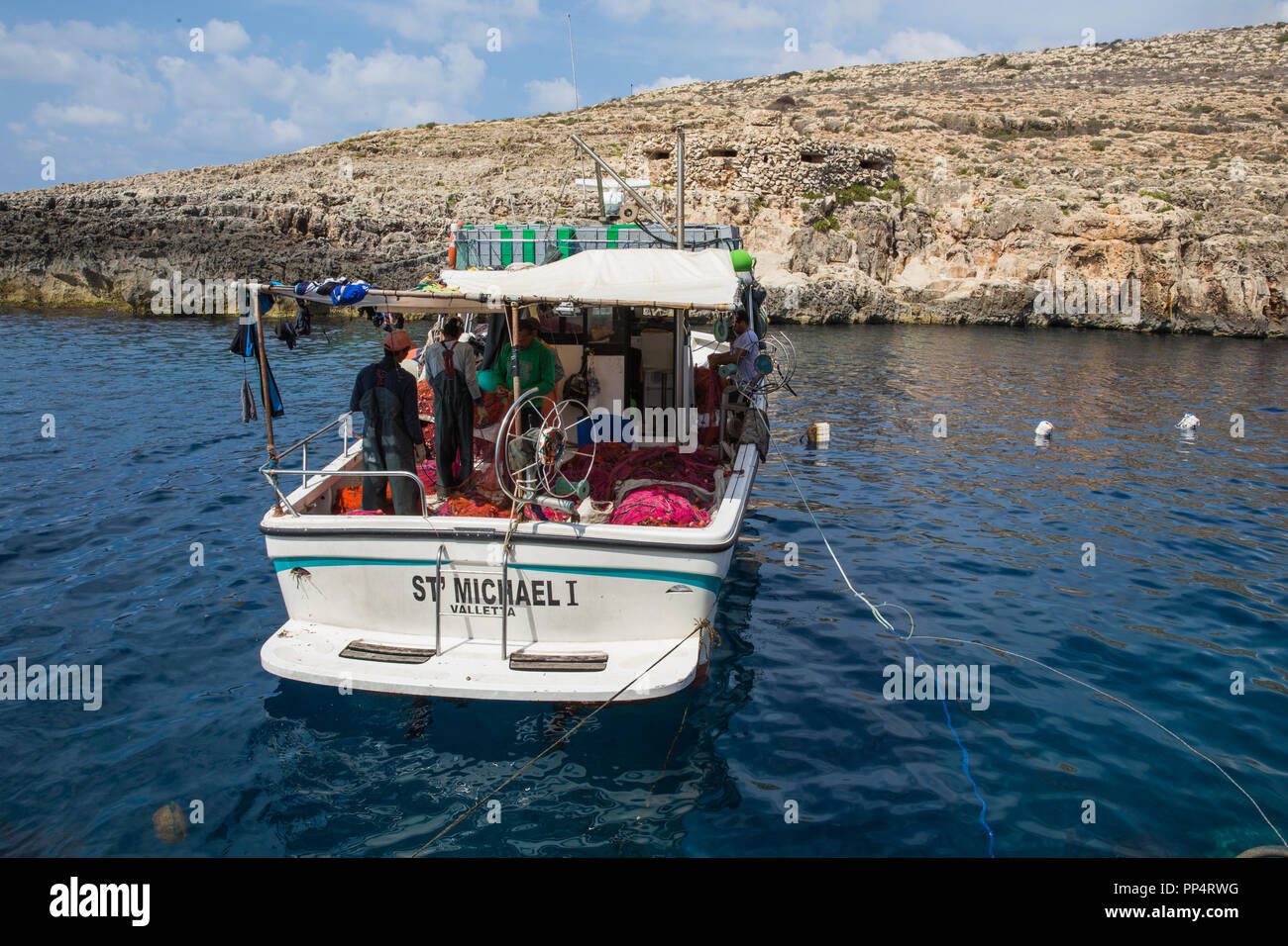 City Gozo, Malta, Europe. Ocean, blue water and boat with peoples. Rock ...