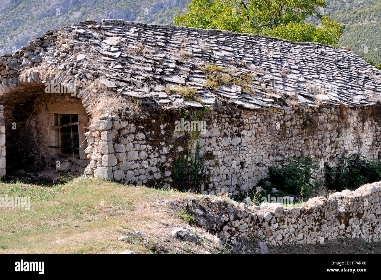Old medieval stone building with boarded up window Stock Photo - Alamy