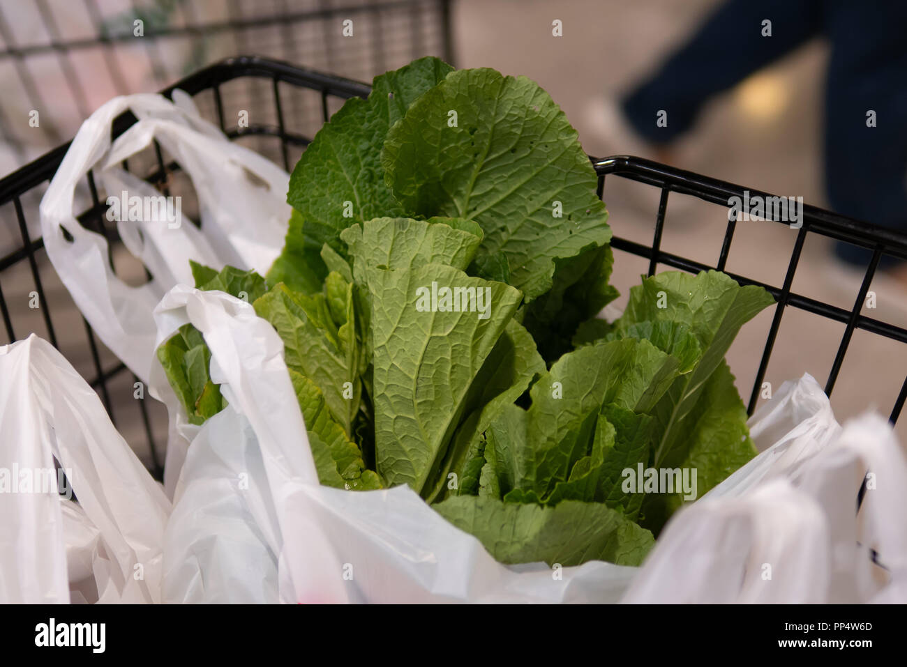 Spinach in plastic bag in shopping cart Stock Photo - Alamy