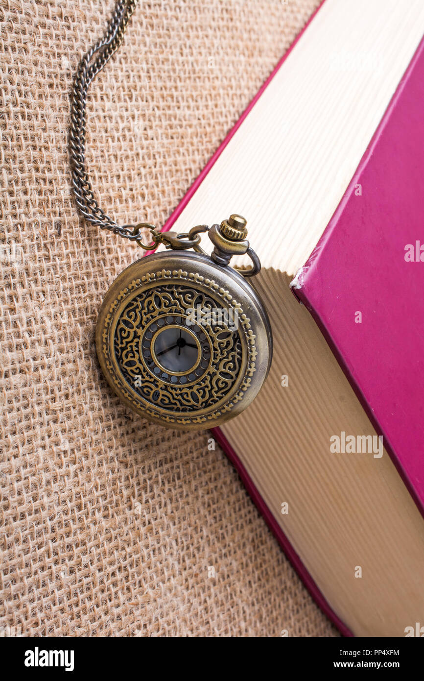 Pocket watch book stack hi-res stock photography and images - Alamy