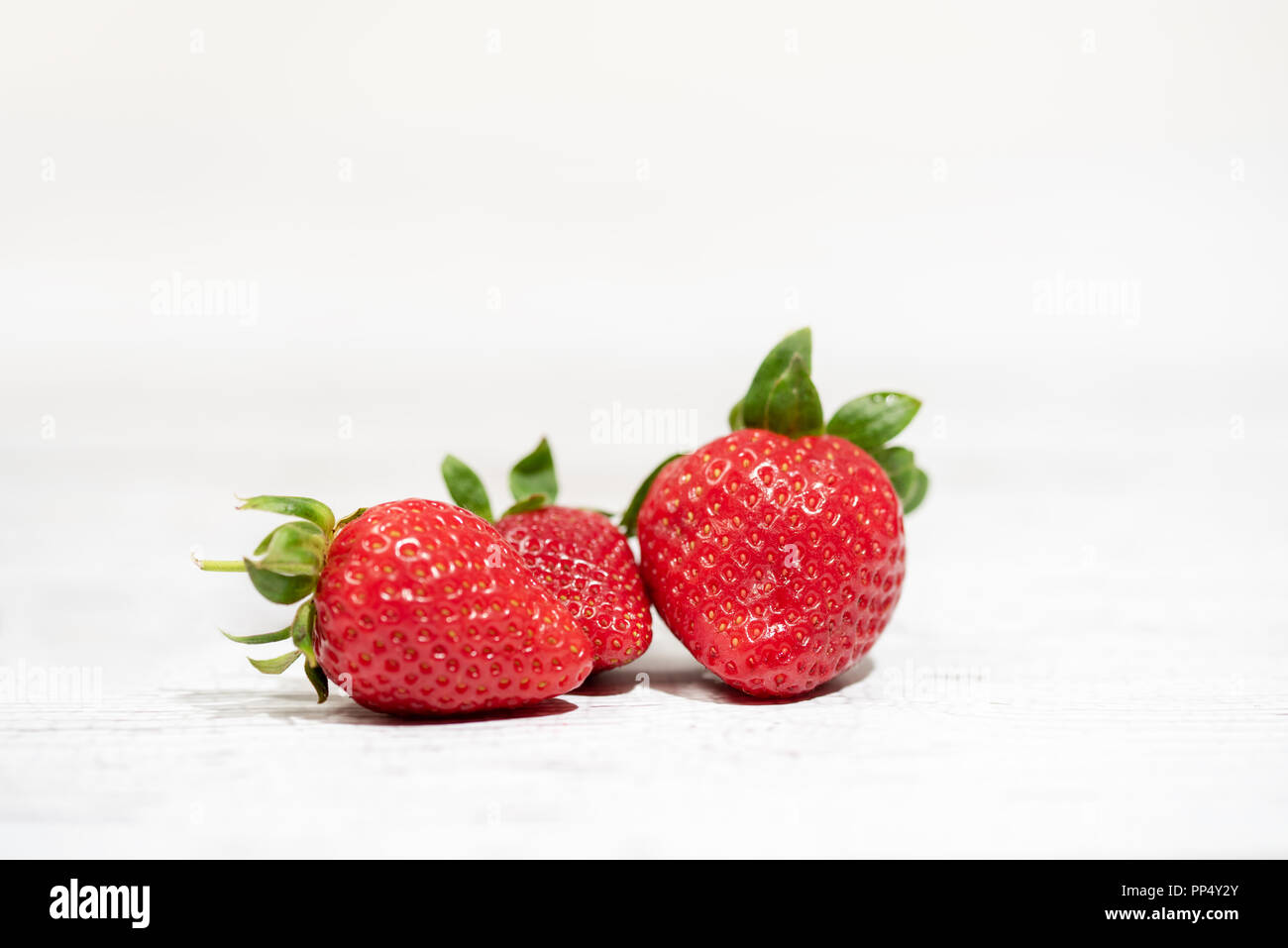 Strawberry on a white wood background. selective focus on strawberries ...