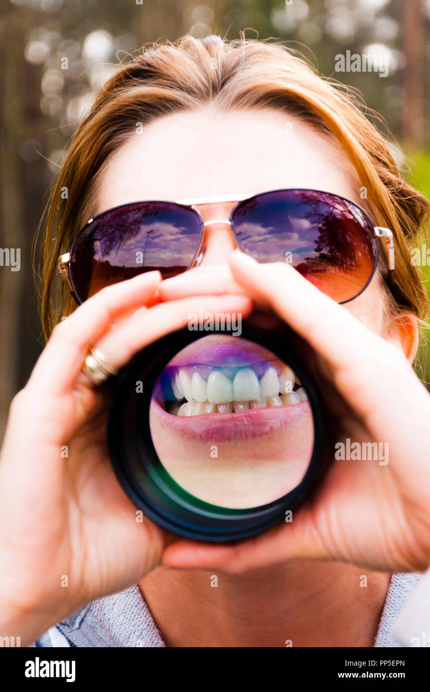 The teeth smile through the magnifying lens. Disproportion is obvious ...