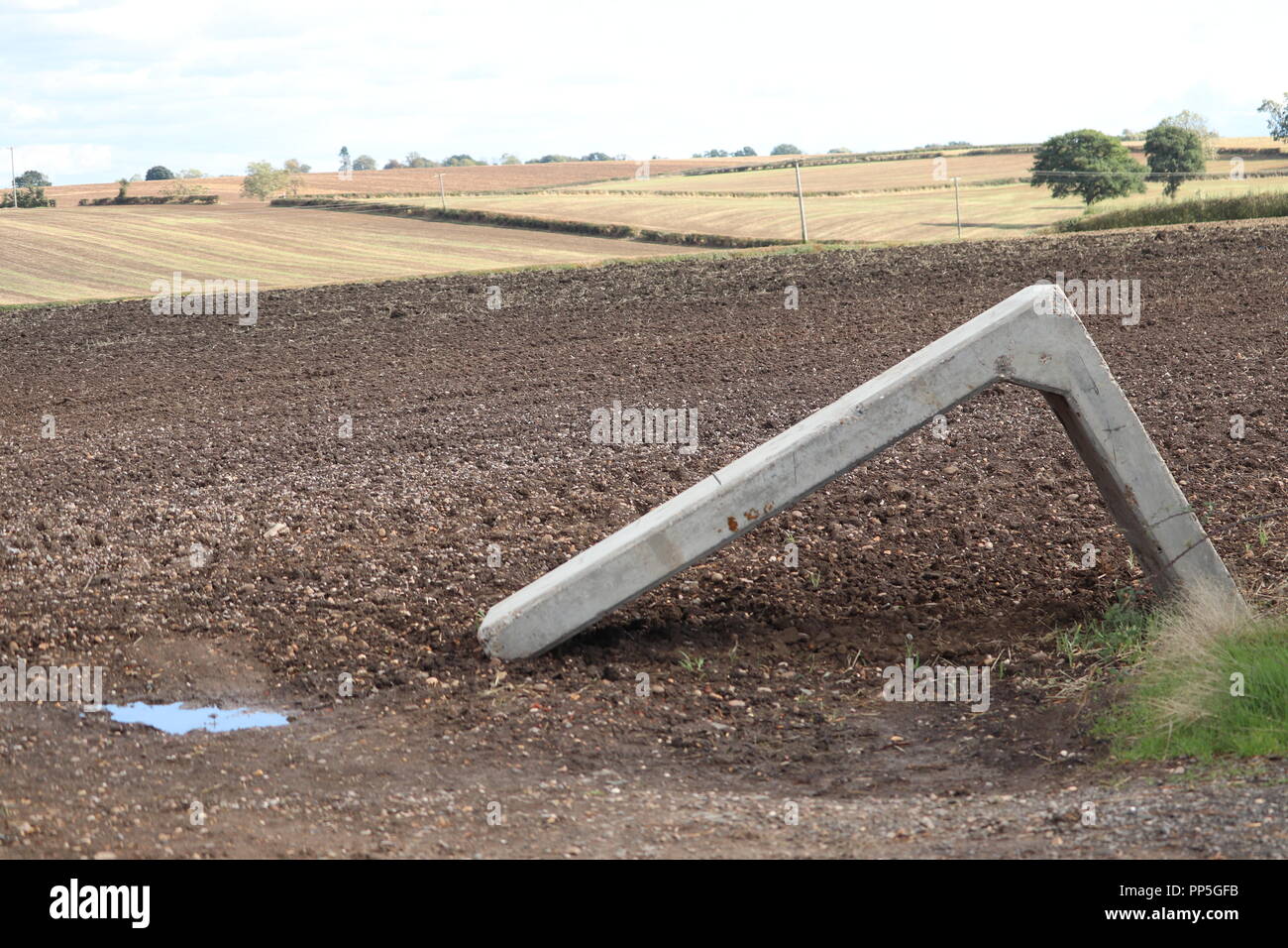 Concrete block on edge of field to stop trespassing Stock Photo - Alamy