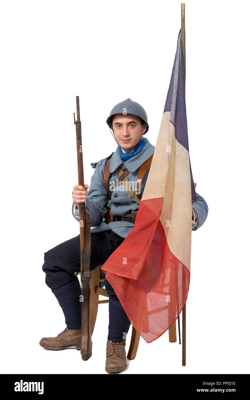 a French soldier, 1914 1918 sitting with flag, isolated on white ...