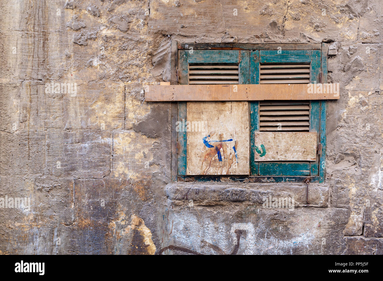 Old grunge window with closed green broken shutters on dirty cracked ...