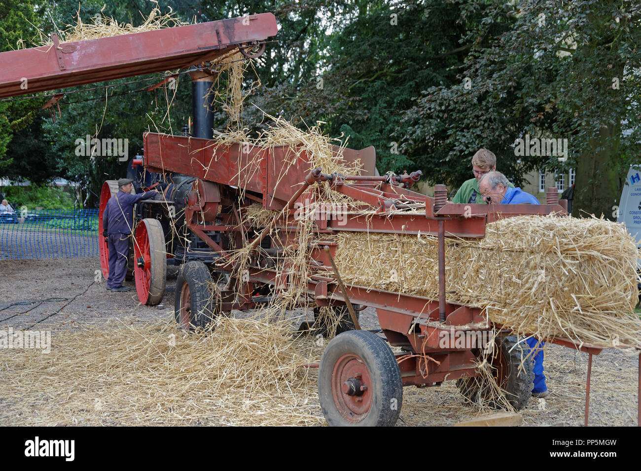 Vintage steam traction engine driving a straw baling machine Stock ...