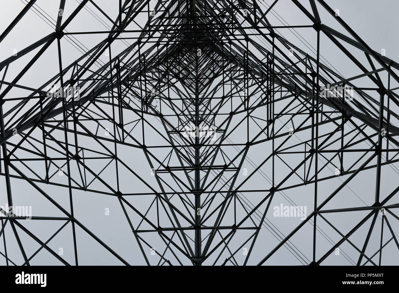 Abstract upward view from below the steel structure of a high voltage ...
