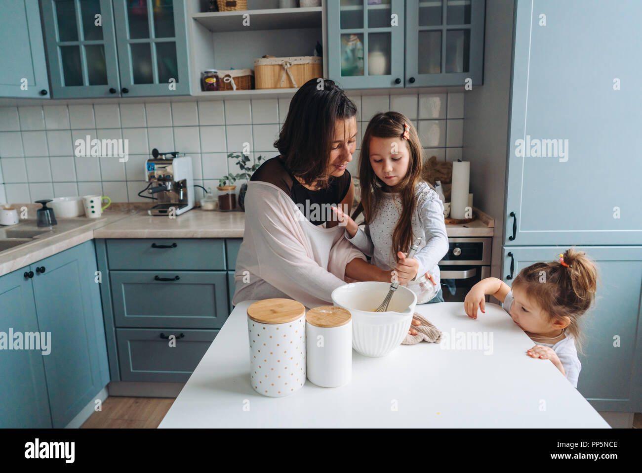 Happy family cook together in the kitchen Stock Photo - Alamy