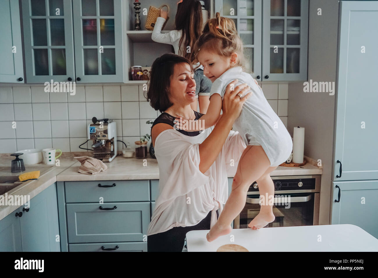 Happy family having fun in the kitchen Stock Photo - Alamy