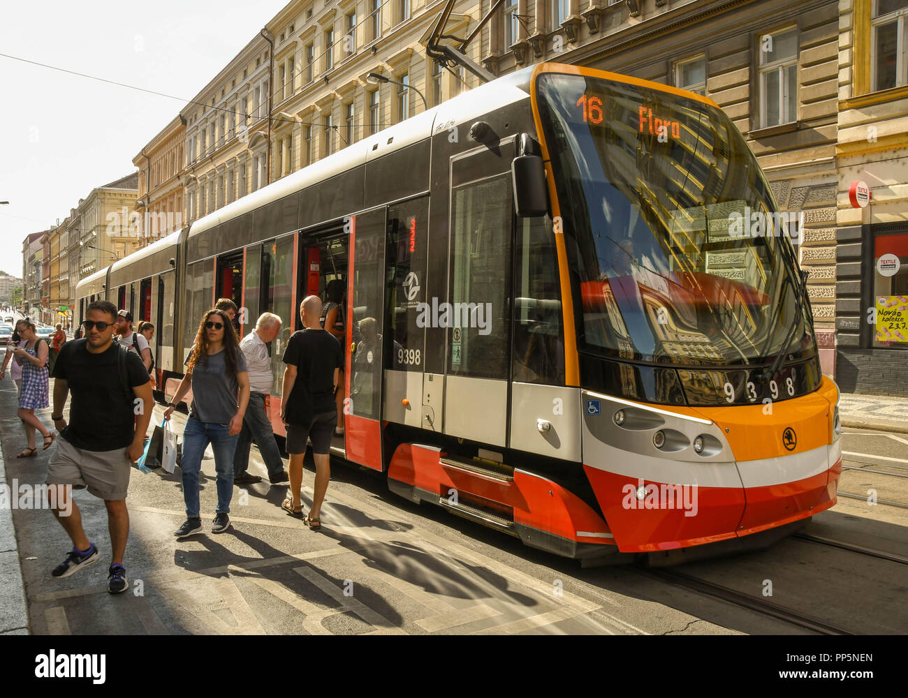 People getting off and people boarding a tram at a tram stop in the ...