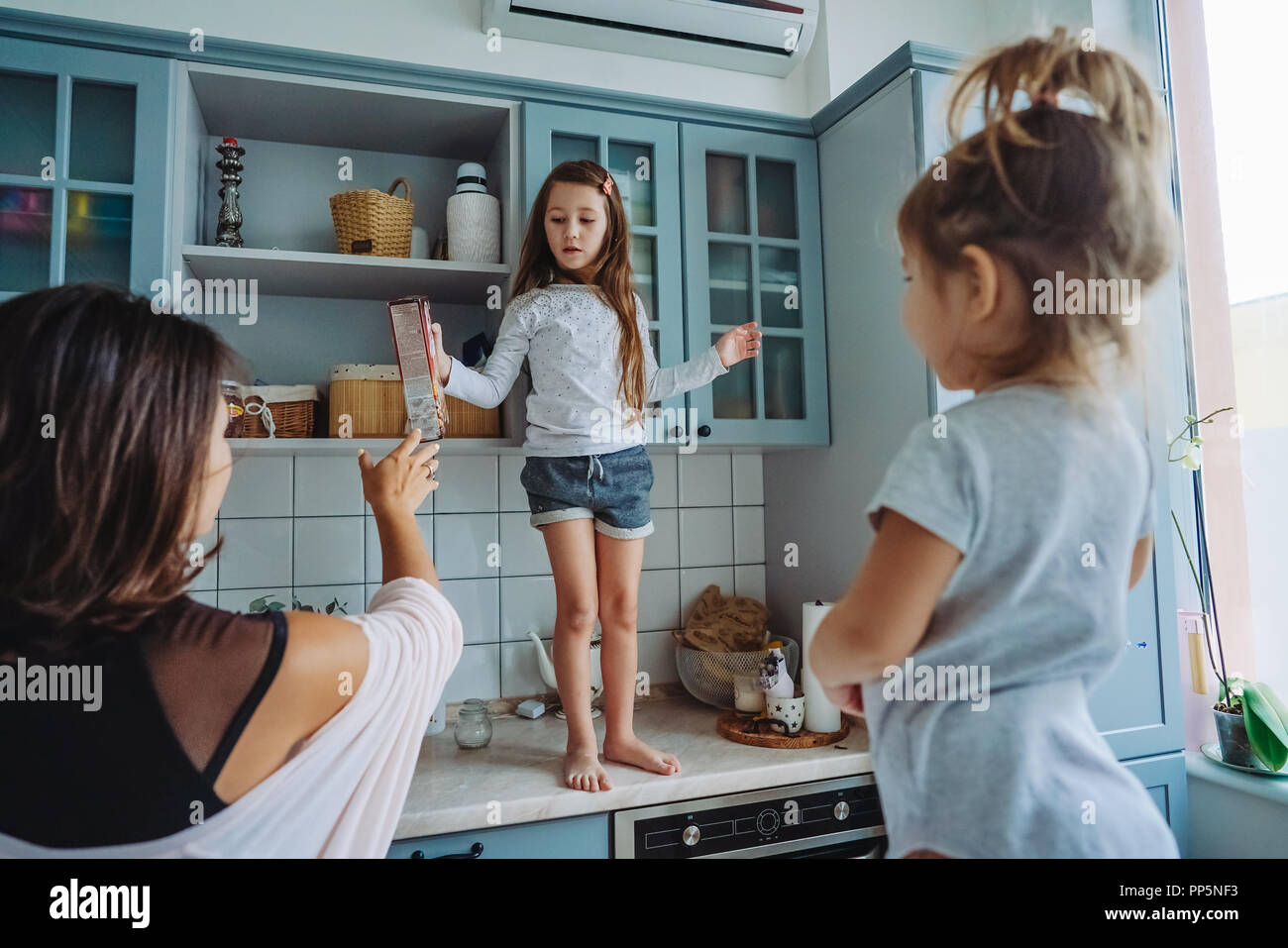 Happy family having fun in the kitchen Stock Photo - Alamy