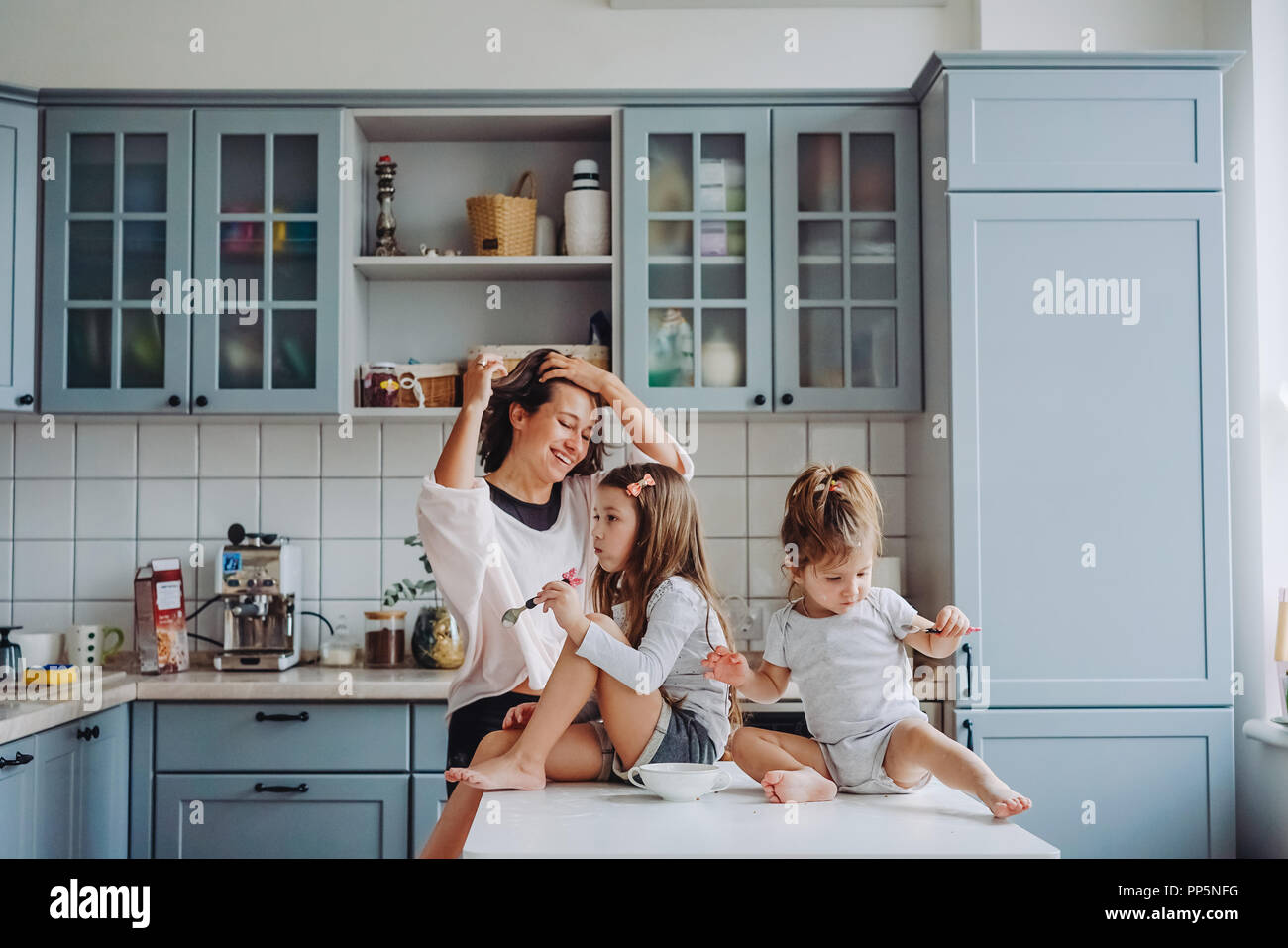 Happy family having fun in the kitchen Stock Photo - Alamy