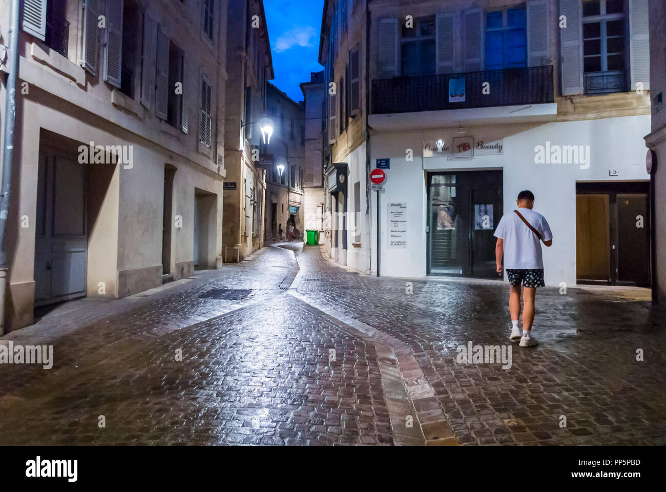 Avignon, FRANCE, Man Walking Away on Street, at Night Alone, Old City ...