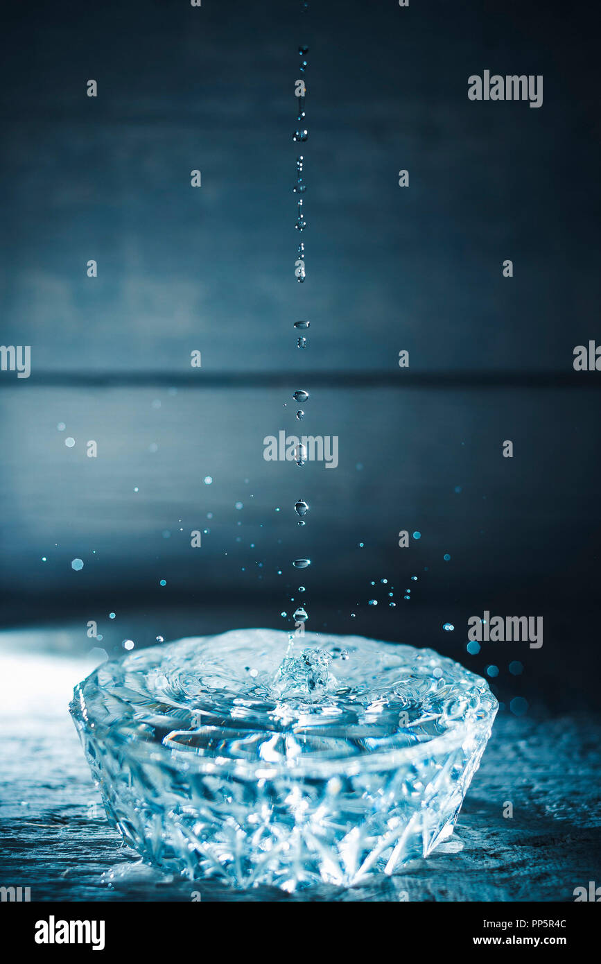 Water dripping into full bowl Stock Photo - Alamy