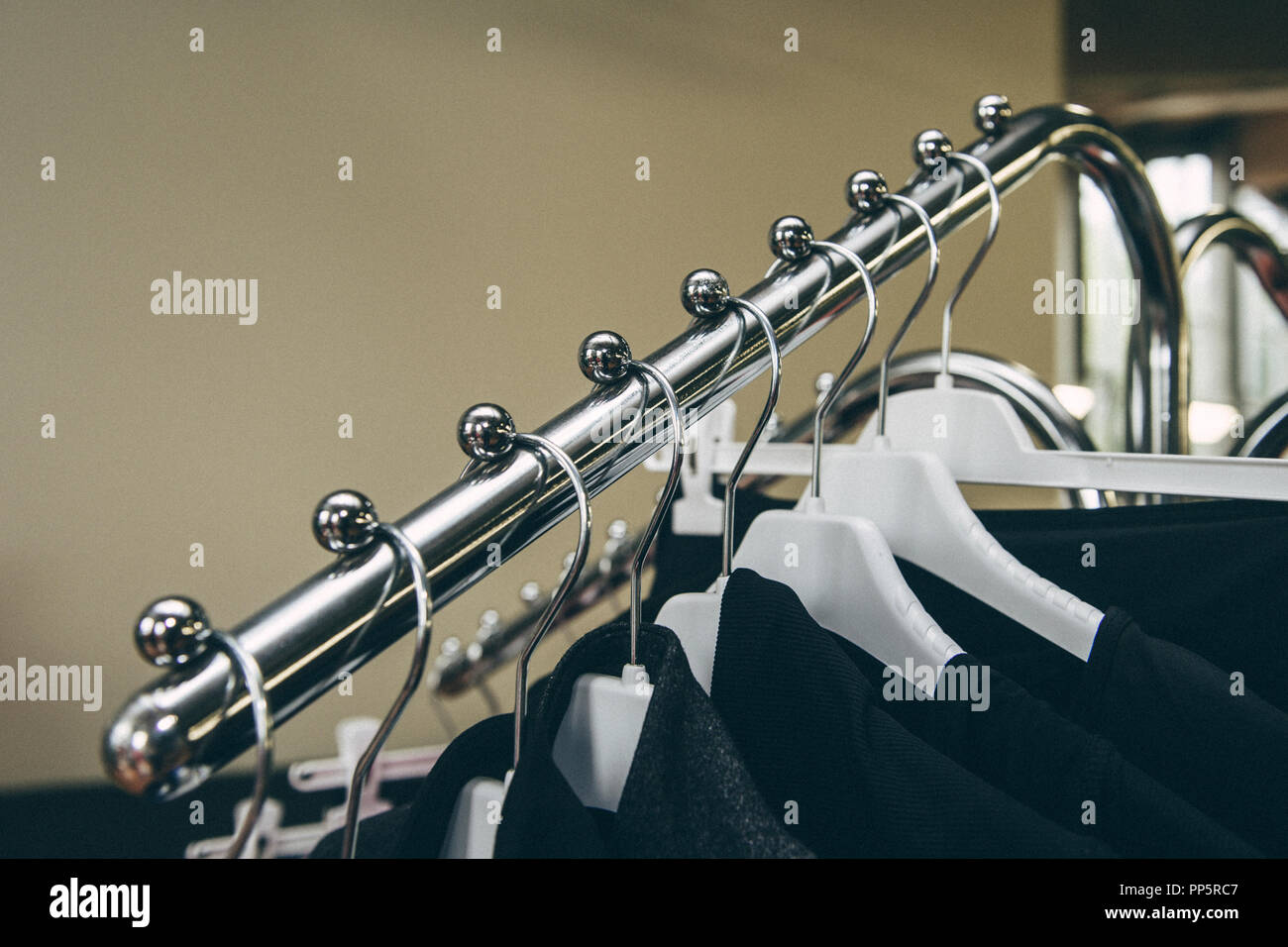 clothes hanging on a rack in a flea market Stock Photo - Alamy