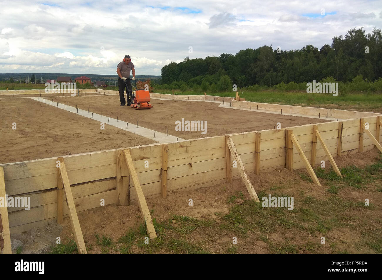Soil compaction by a worker with a vibroplate 2018 Stock Photo - Alamy