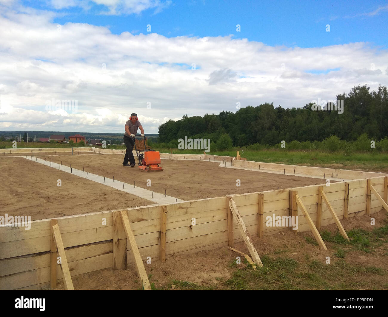 Soil compaction by a worker with a vibroplate 2018 Stock Photo - Alamy