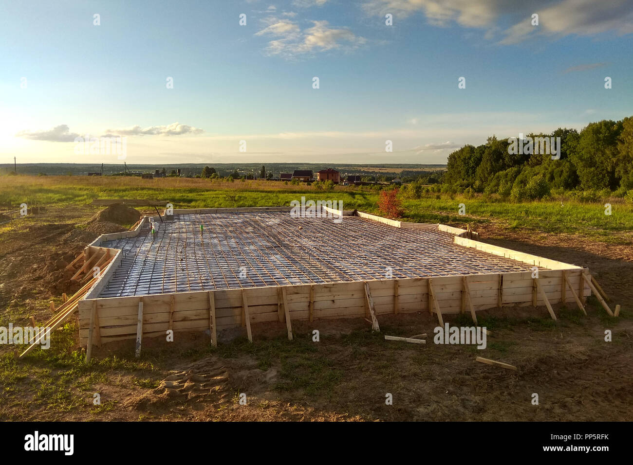 inspection well, trench and concrete slab of foundation with wooden ...