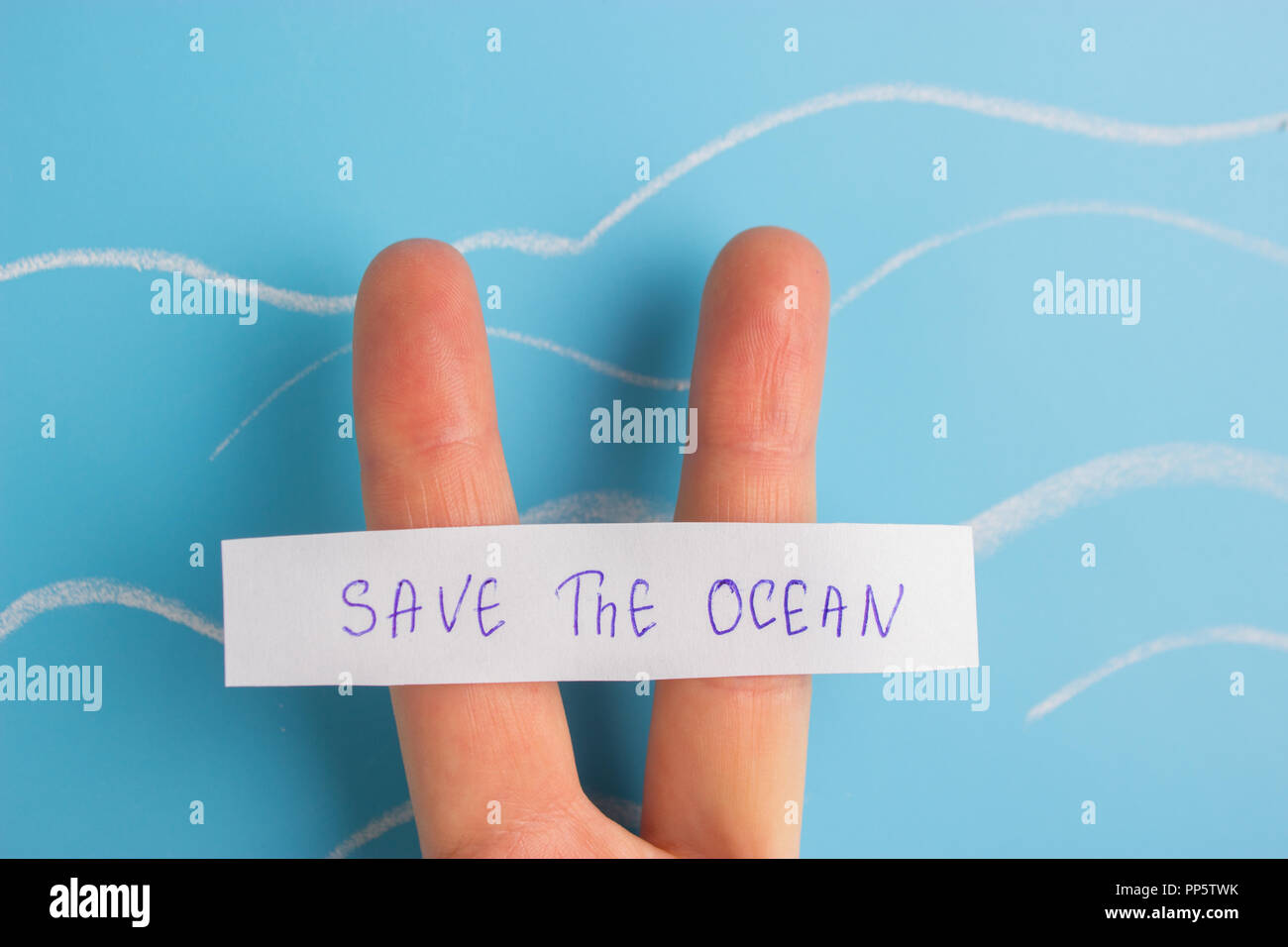 save the ocean concept. two fingers with sing Stock Photo - Alamy