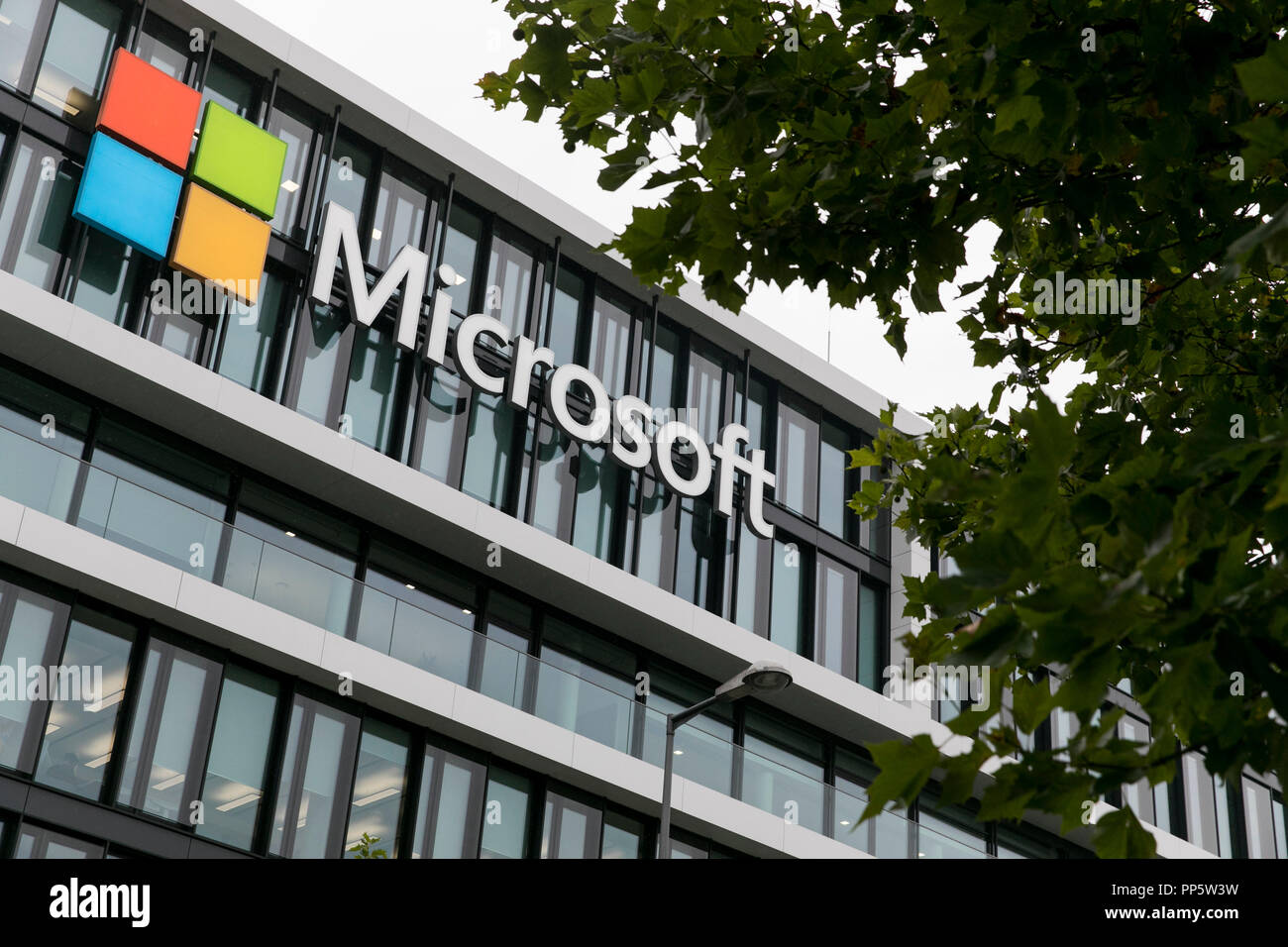 A logo sign outside of a facility occupied by Microsoft in Munich ...