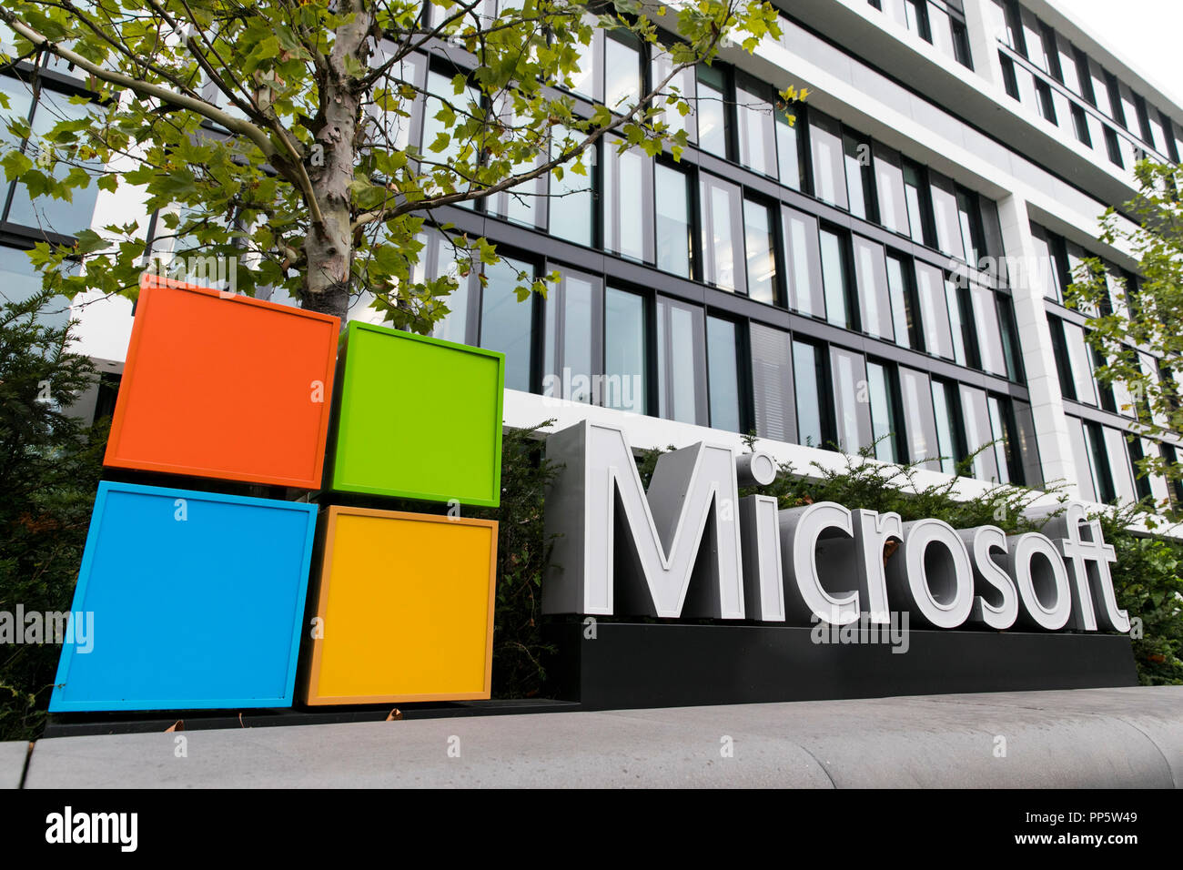 A logo sign outside of a facility occupied by Microsoft in Munich ...