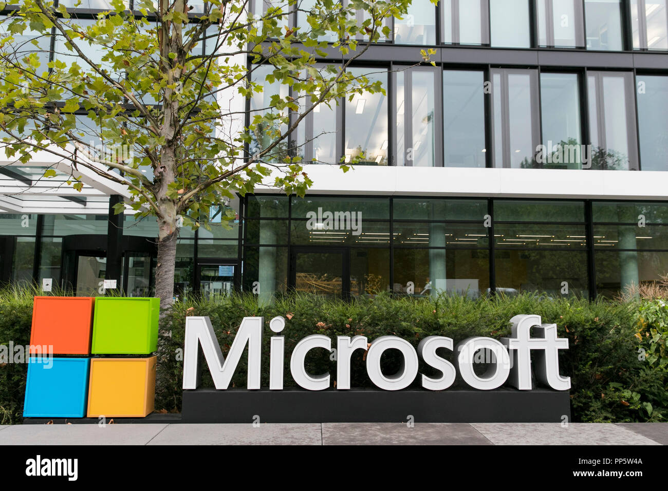 A logo sign outside of a facility occupied by Microsoft in Munich ...