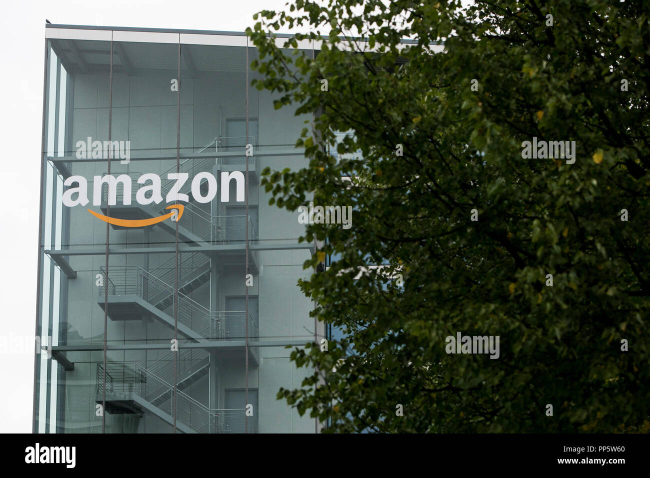 A logo sign outside of a facility occupied by Amazon in Munich, Germany ...