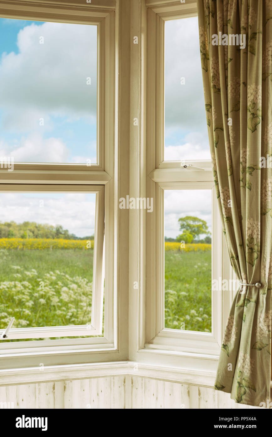 Corner window overlooking a summer landscape Stock Photo - Alamy