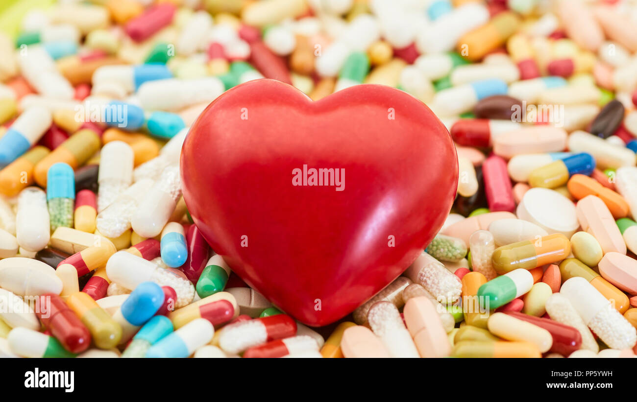 Red heart on many colorful medicines as a health concept Stock Photo ...