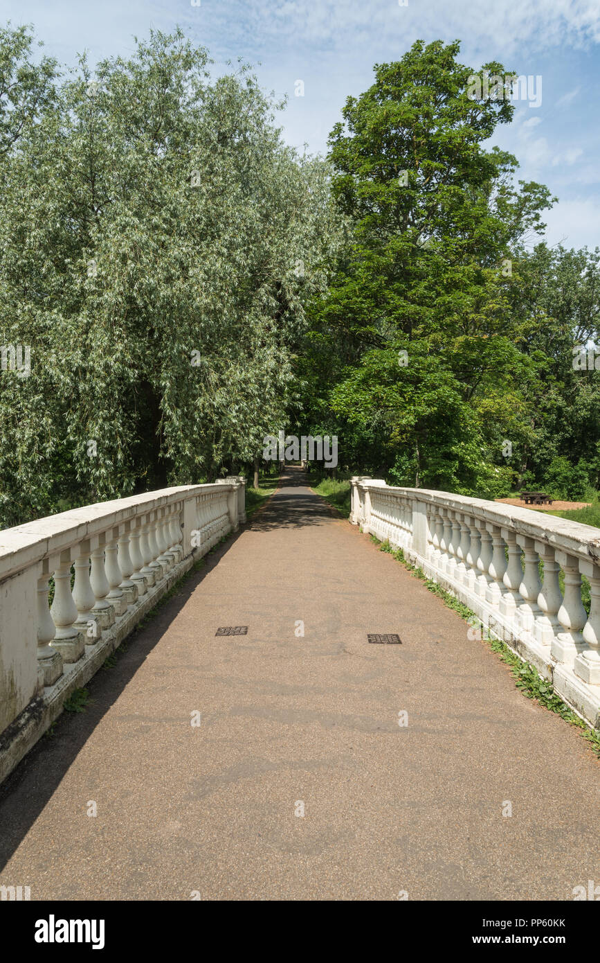 View along the bridge over the lake with white stone pillars in Stanley ...