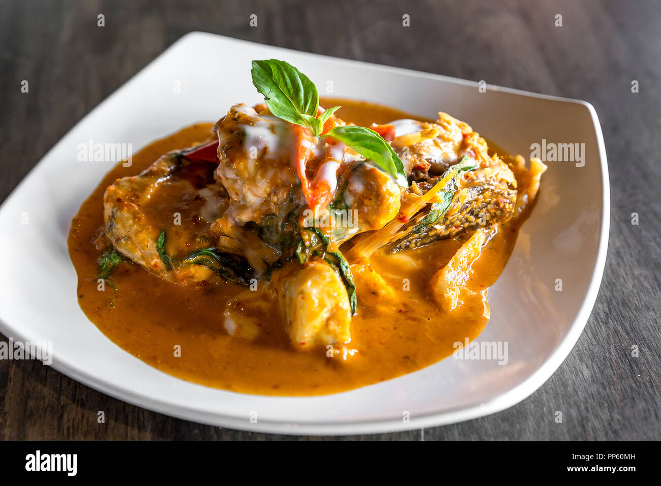 Fried grouper Fish with Red Curry Paste Chu Chee Pla Stock Photo - Alamy