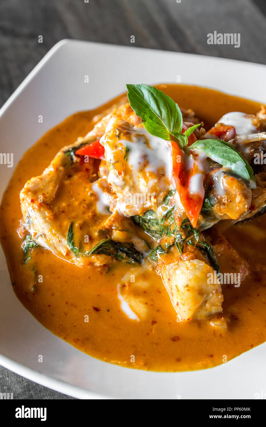 Fried grouper Fish with Red Curry Paste Chu Chee Pla Stock Photo - Alamy