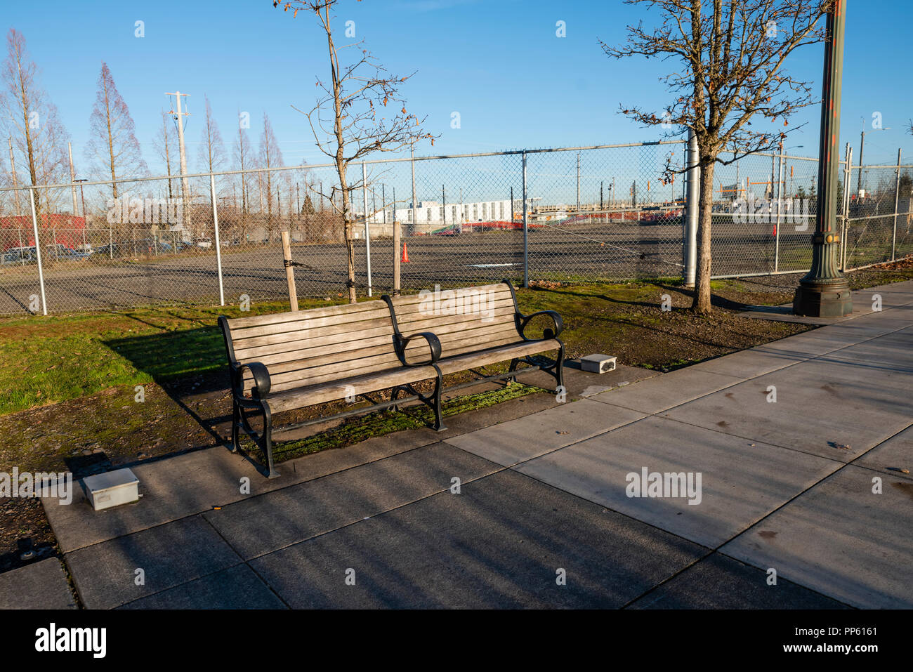 Park bench along a sidewalk near the Portland Eastbank Esplanade ...