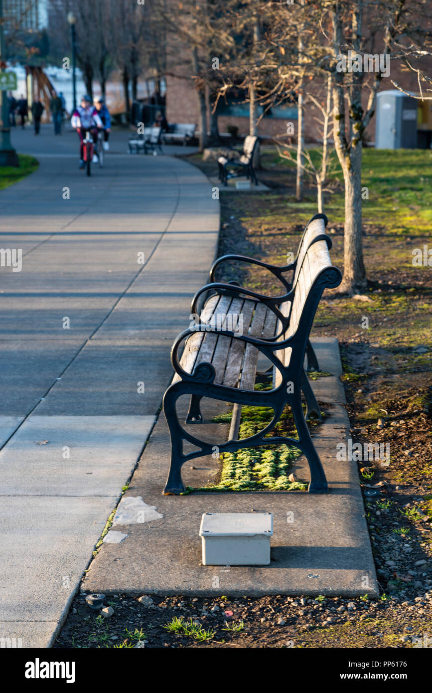 Park bench along a sidewalk near the Portland Eastbank Esplanade ...