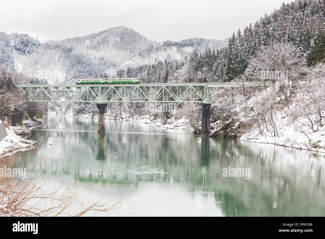 Train in Winter landscape snow on bridge Stock Photo - Alamy