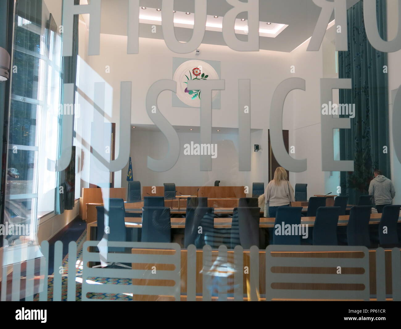 The word "Justice" is part of the engraving in the glass screen at the ...