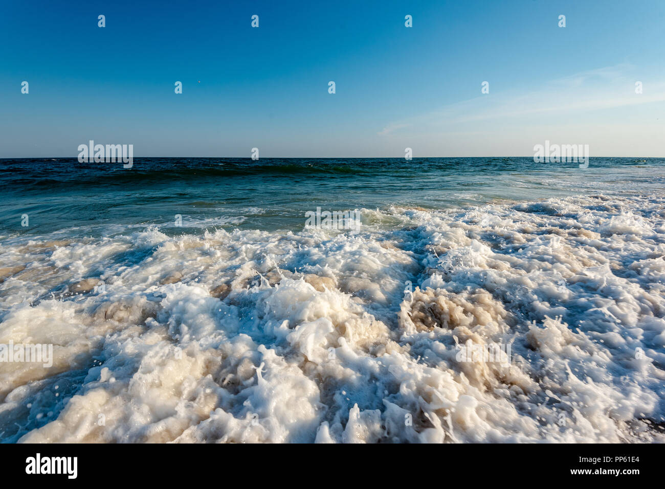 Ocean waves on a sunny sandy beach Stock Photo - Alamy
