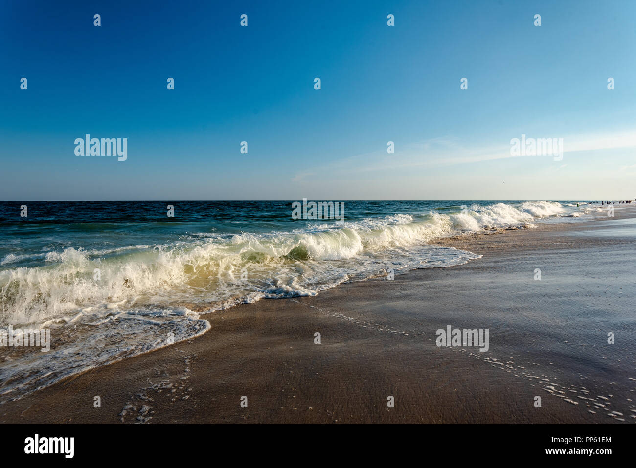 Ocean waves on a sunny sandy beach Stock Photo - Alamy