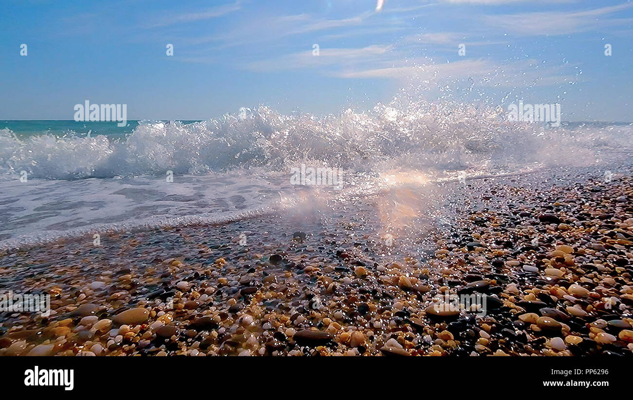 The wave runs on the beach in summer on a Sunny day Stock Photo - Alamy