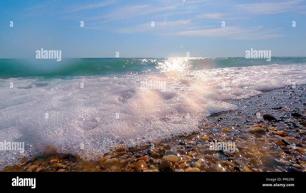 The wave runs on the beach in summer on a Sunny day Stock Photo - Alamy