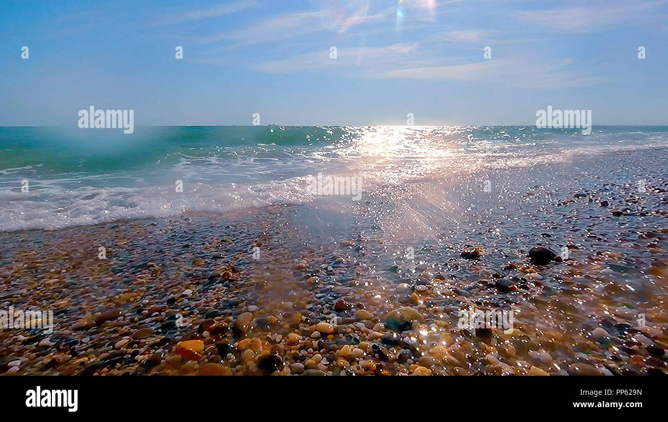 The wave runs on the beach in summer on a Sunny day Stock Photo - Alamy