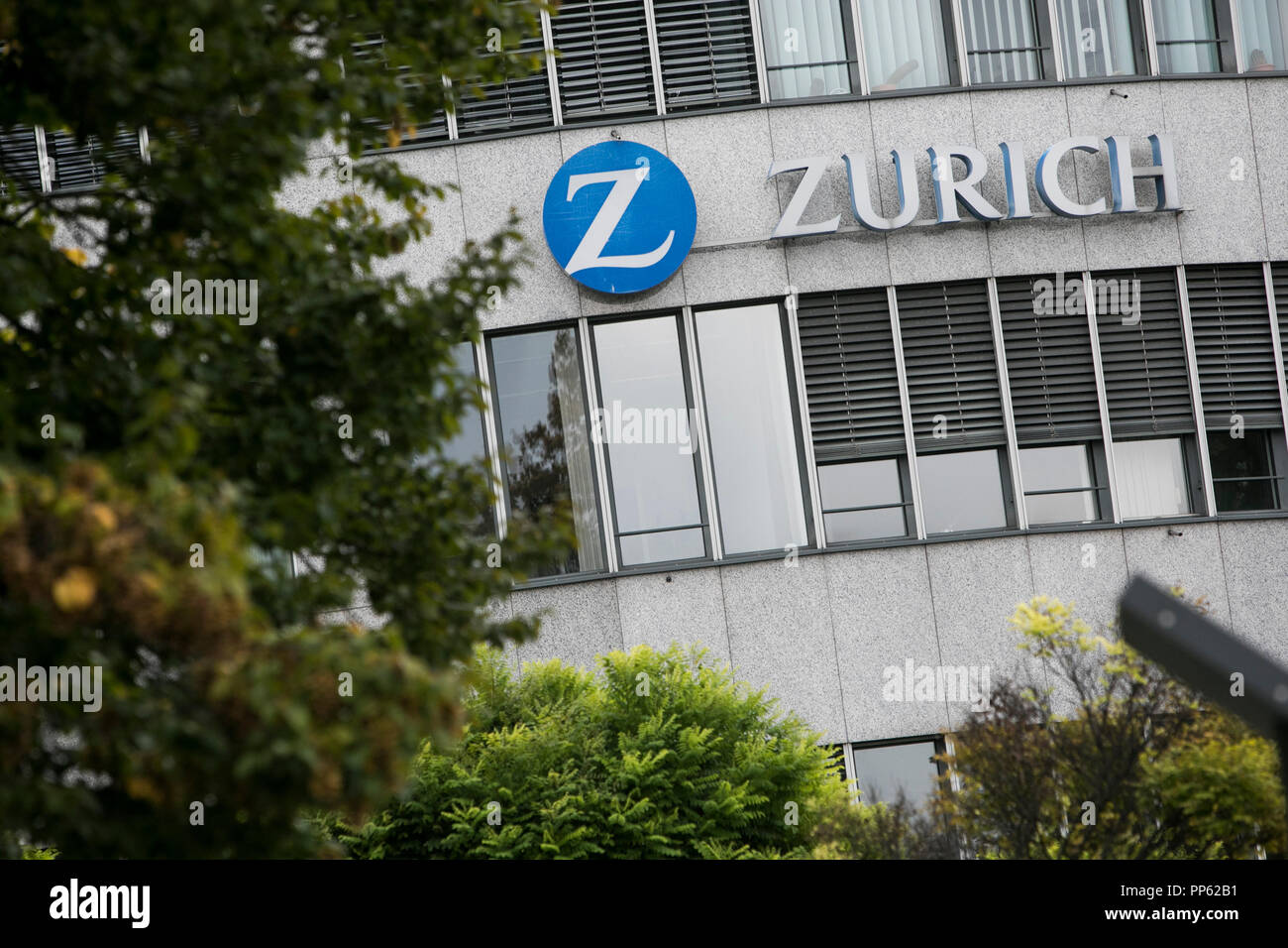 A logo sign outside of a facility occupied by the Zurich Insurance ...