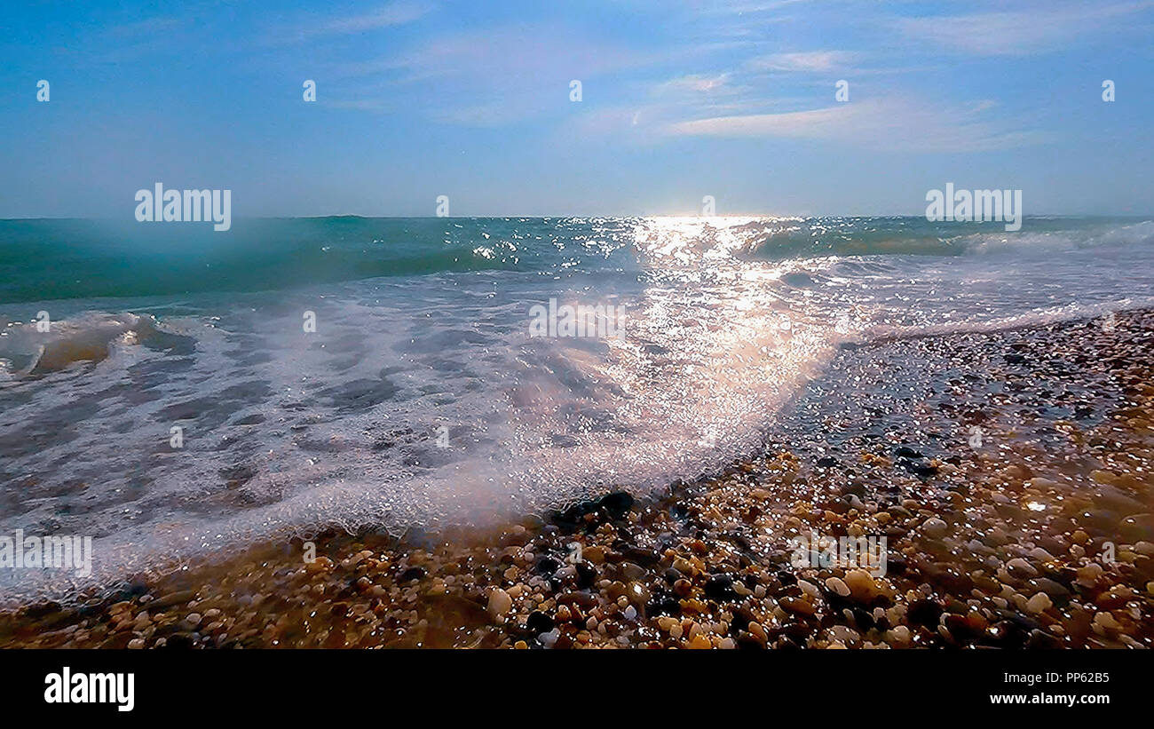 The wave runs on the beach in summer on a Sunny day Stock Photo - Alamy
