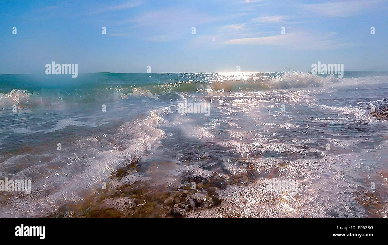 The wave runs on the beach in summer on a Sunny day Stock Photo - Alamy