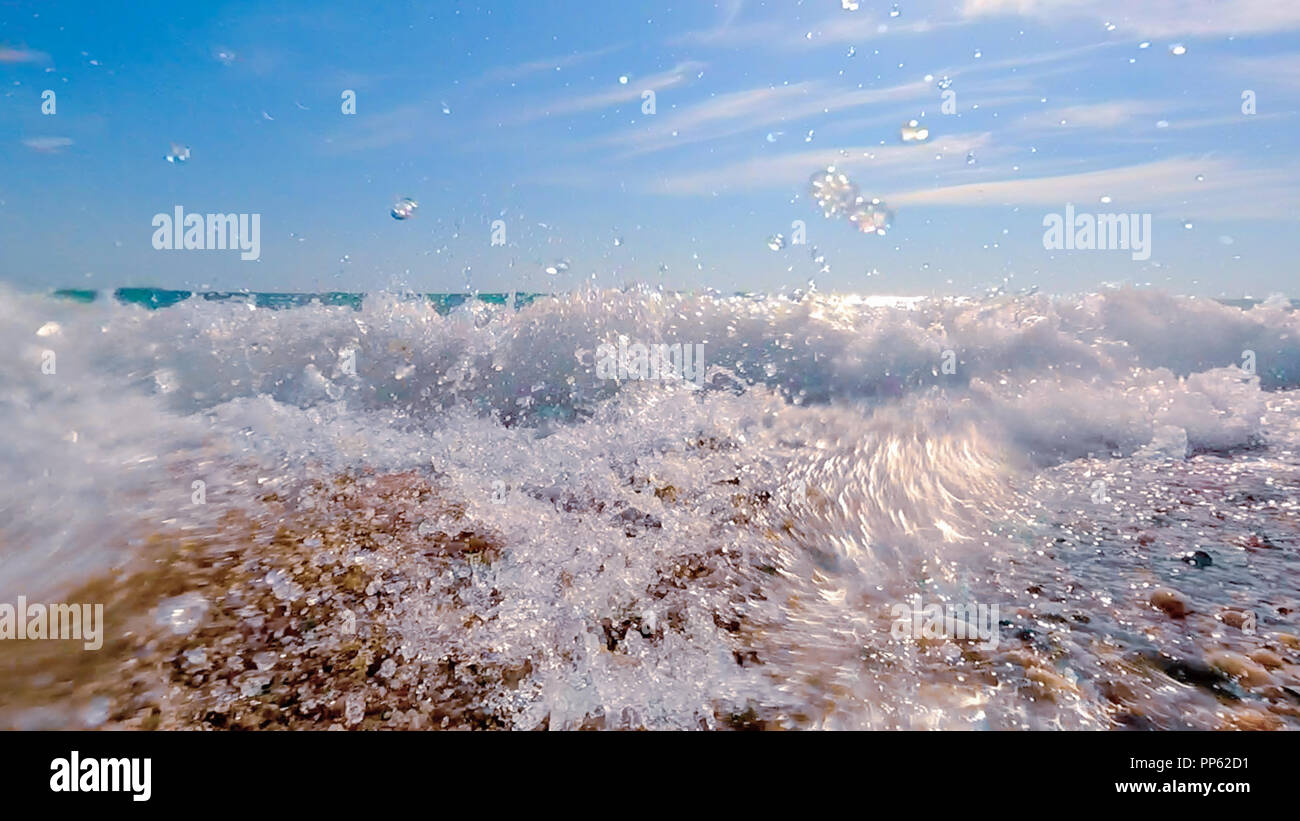 The wave runs on the beach in summer on a Sunny day Stock Photo - Alamy