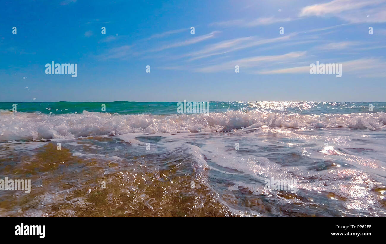 The wave runs on the beach in summer on a Sunny day Stock Photo - Alamy