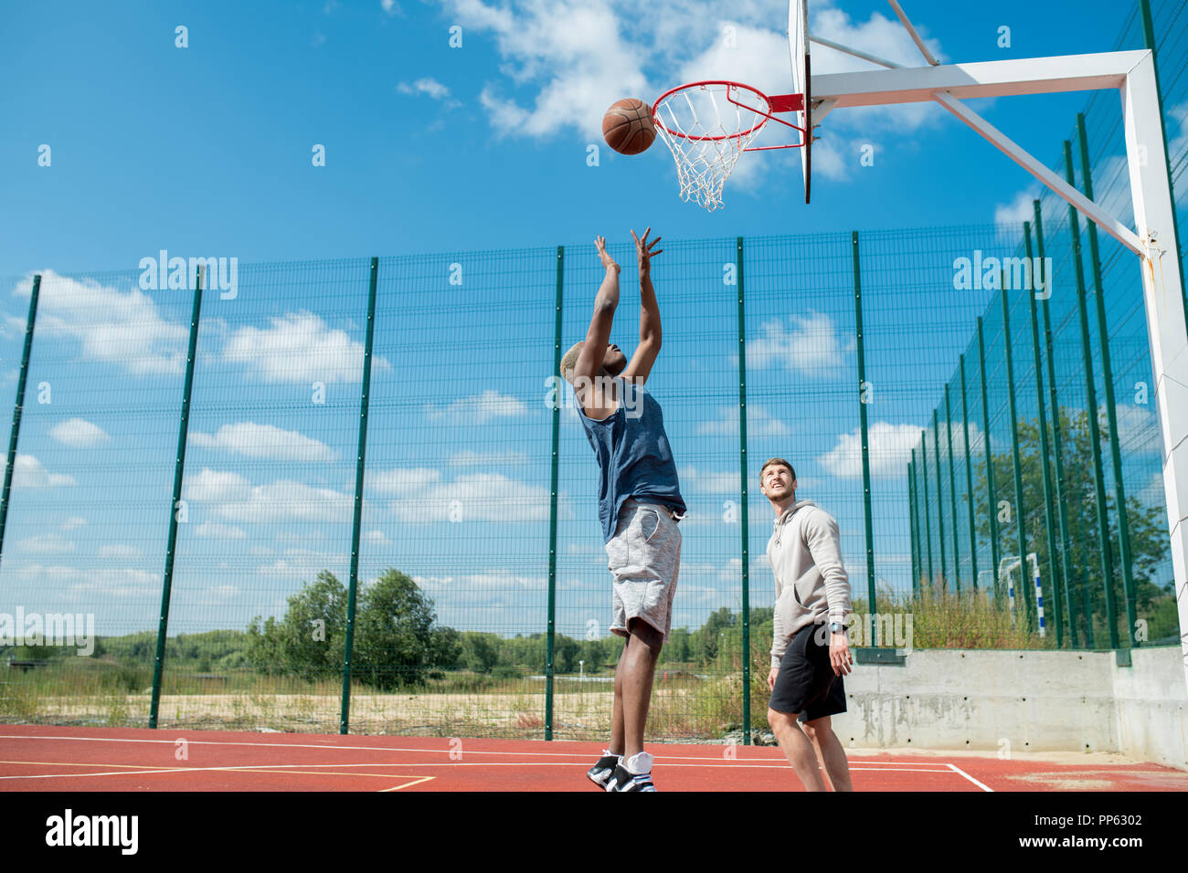Two Young Men Playing Basketball Outdoors Stock Photo - Alamy