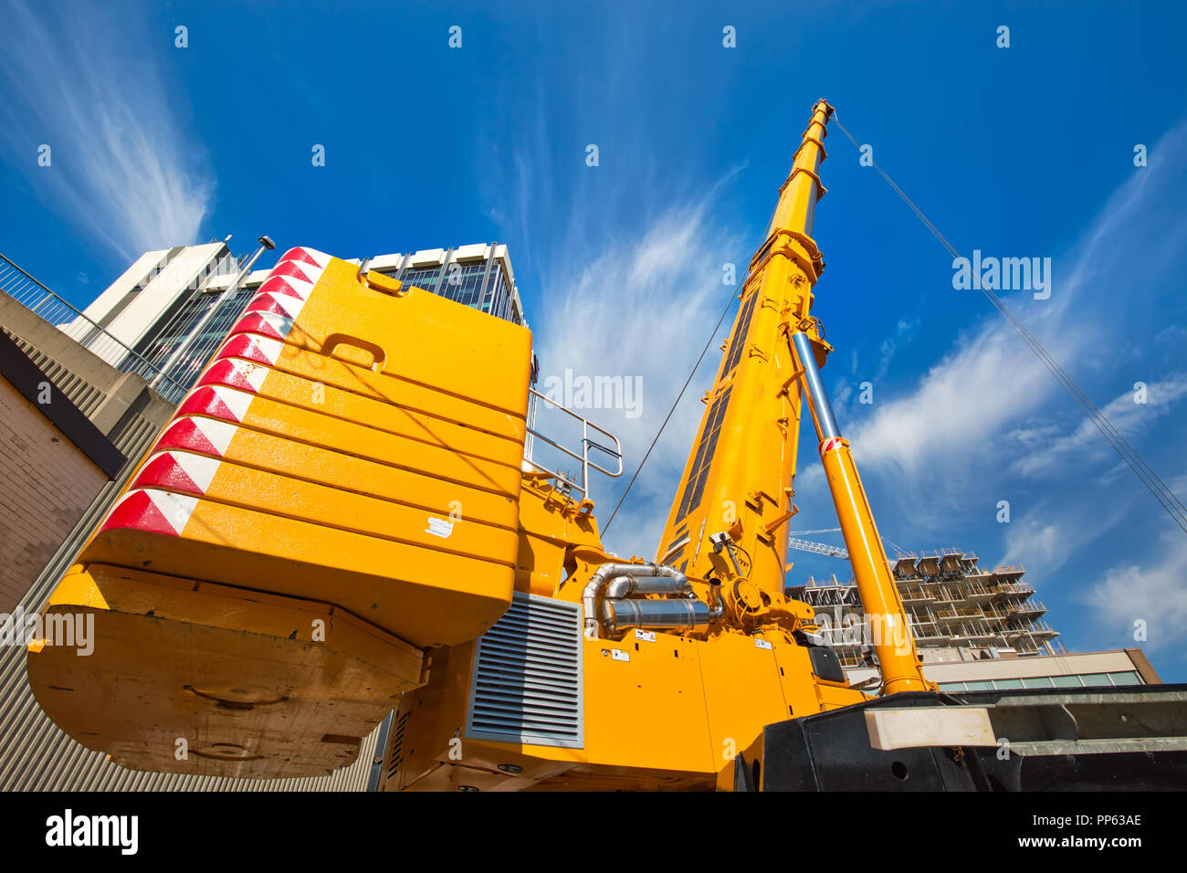 Mobile crane at work at downtown construction site Stock Photo - Alamy