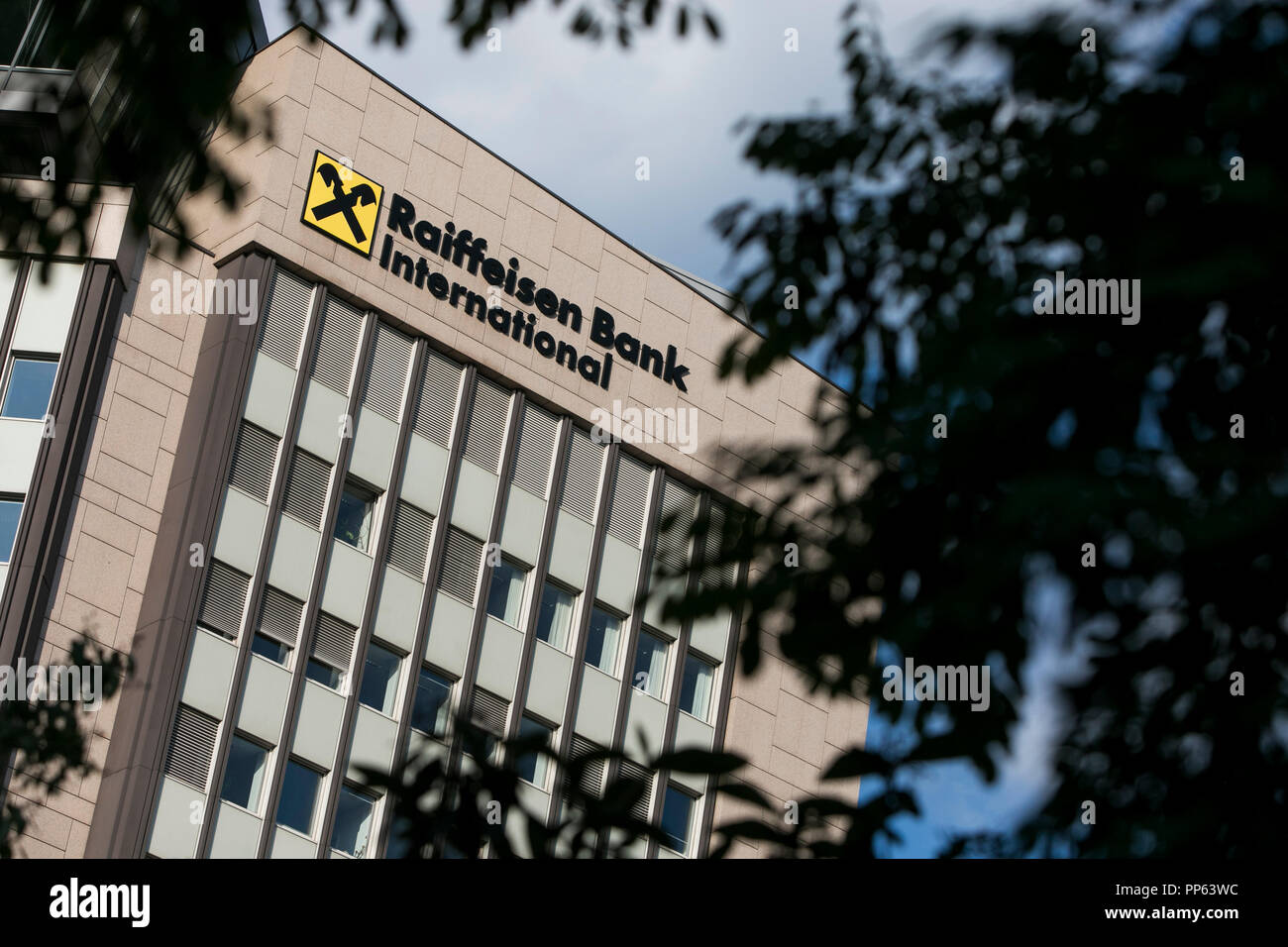 A logo sign outside of the headquarters of Raiffeisen Bank ...