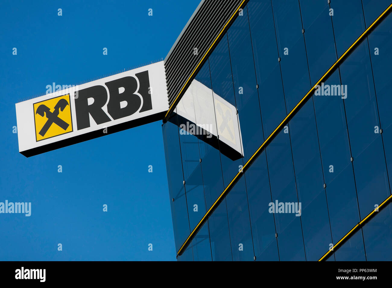 A logo sign outside of the headquarters of Raiffeisen Bank ...